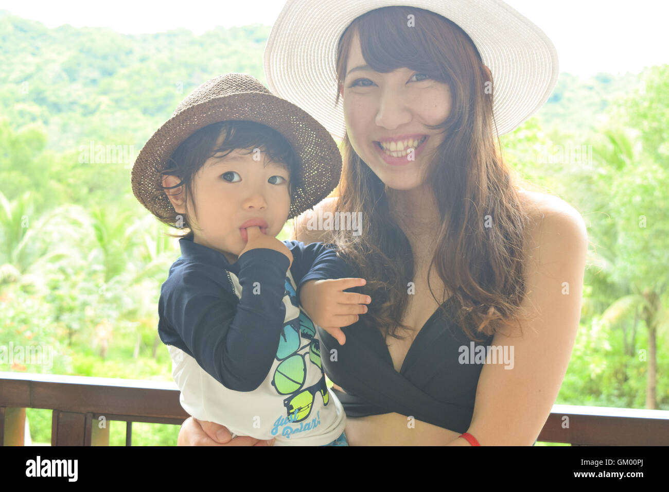 mother and child at flesh forest with hat sun light Stock Photo - Alamy