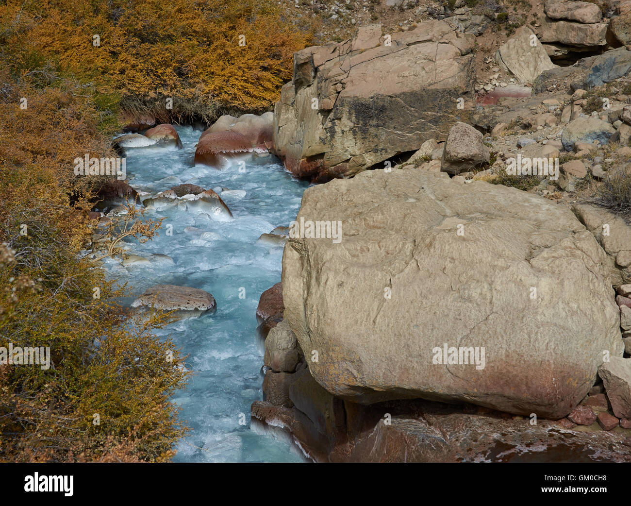 Ice cold river from the Paloma glacier running through autumn coloured ...