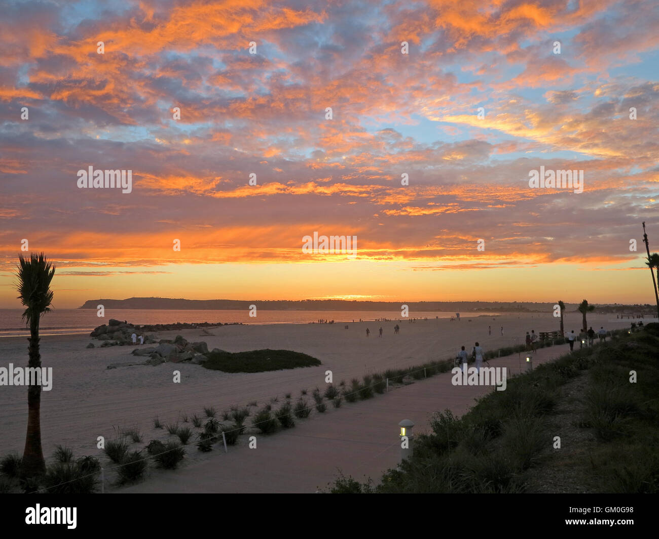 A colorful sunset over the ocean and beach Stock Photo - Alamy
