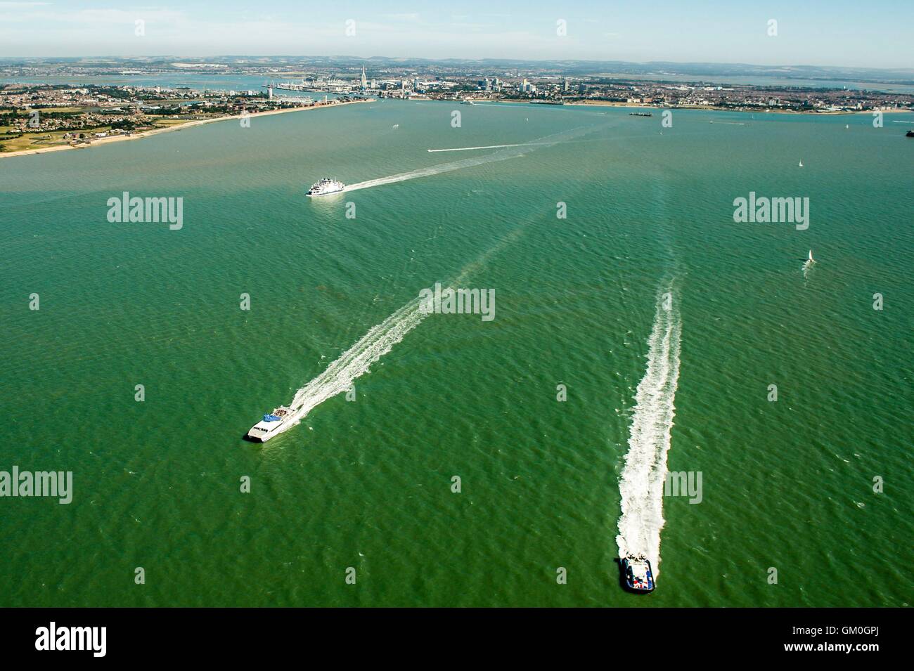 Boats create bow waves in the Solent just off the coast of Portsmouth ...