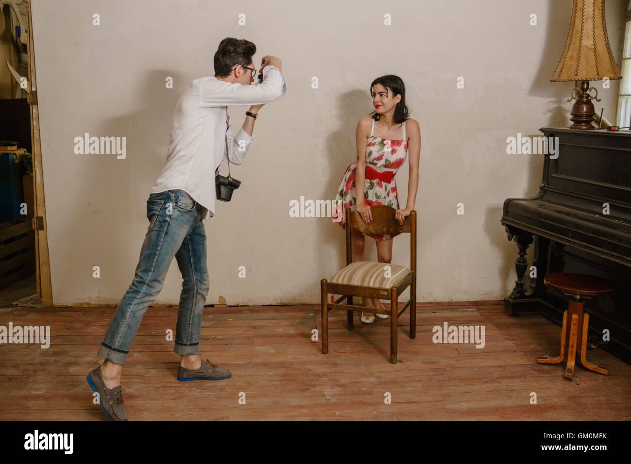 pretty brunette standing behind chair beautifully poses for ...