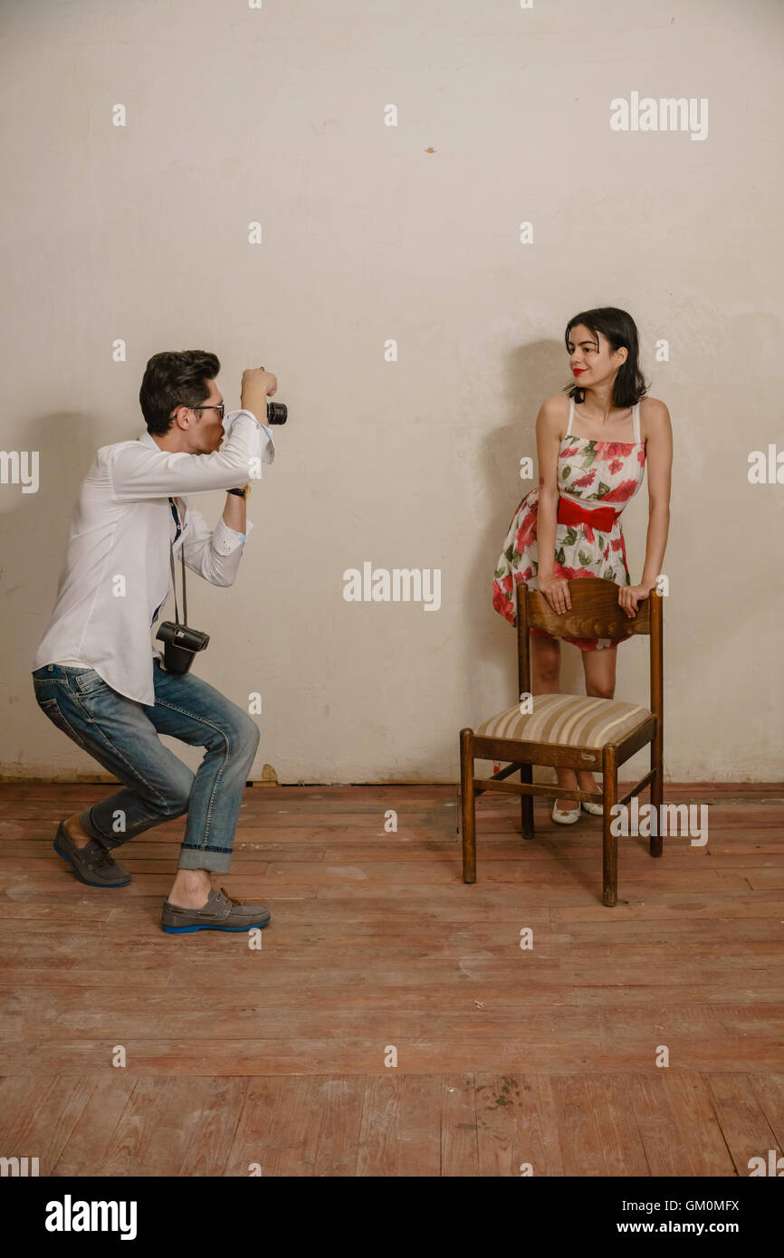 pretty brunette standing behind chair beautifully poses for ...