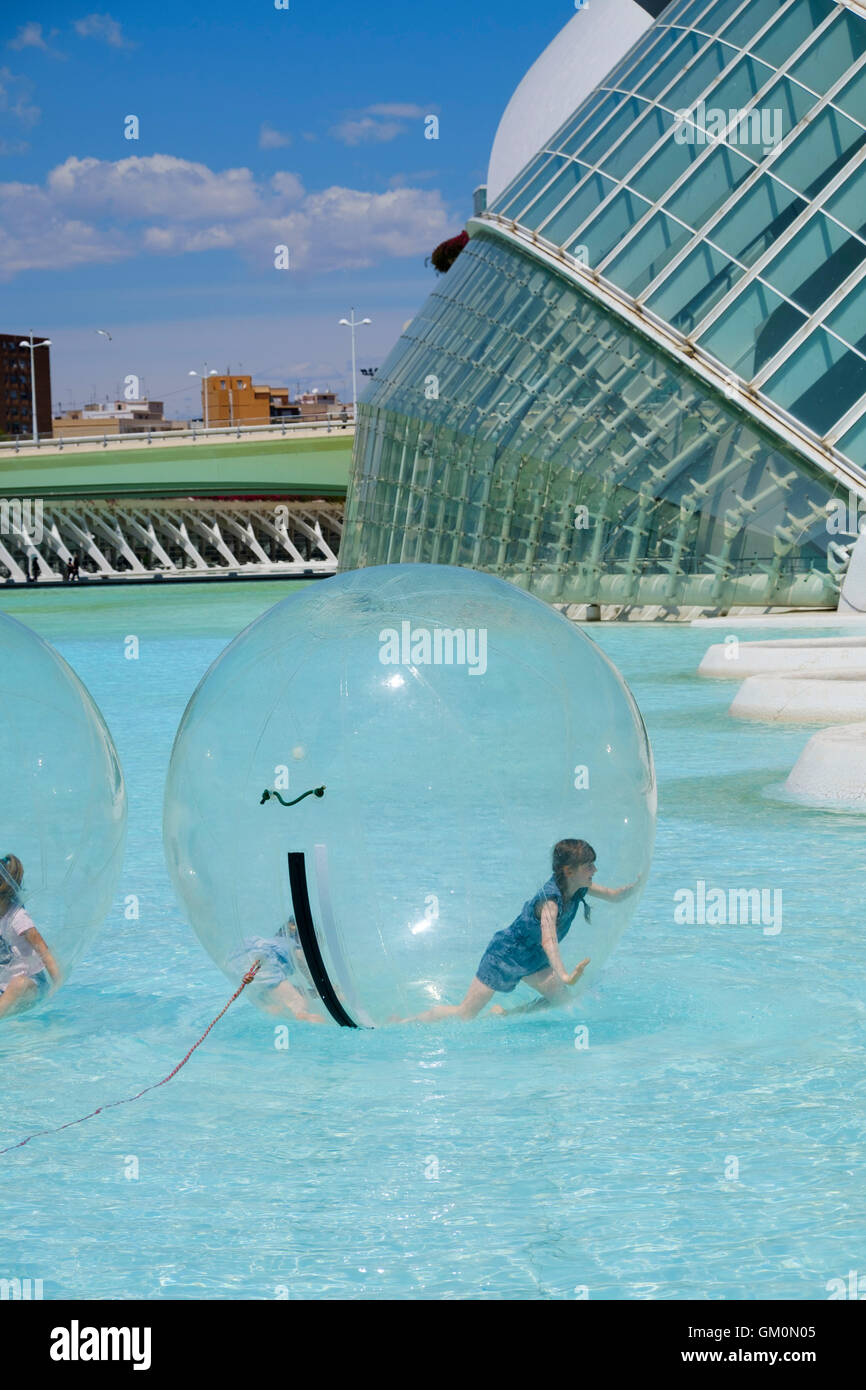 Children inside a water walking ball at the science park in front of ...