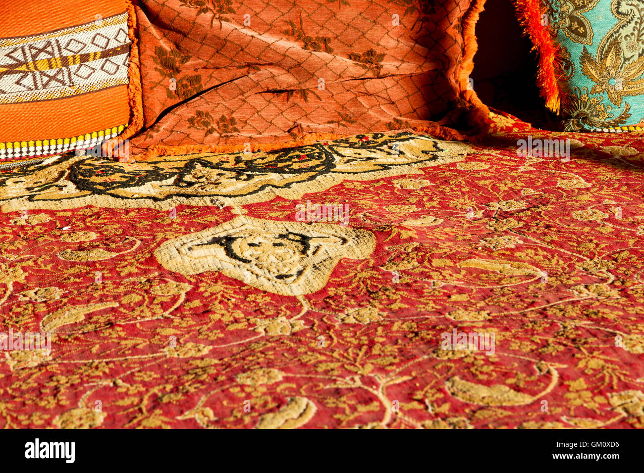 in oman old carpet and pillow like table to rest Stock Photo - Alamy