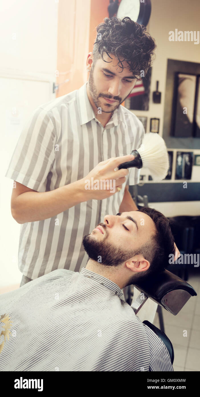 Traditional ritual of shaving the beard in a old style barber shop ...