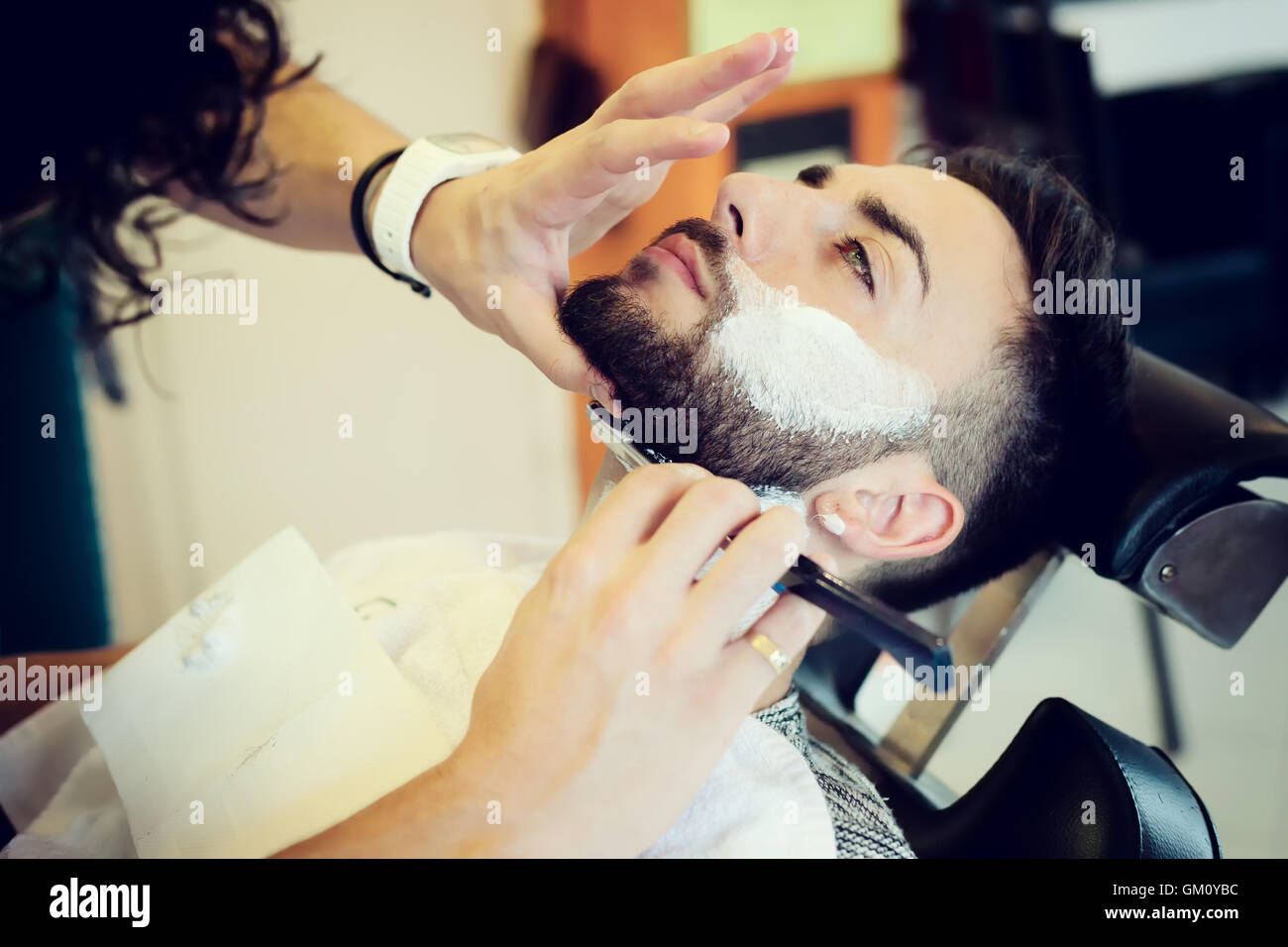 Traditional ritual of shaving the beard in a old style barber shop ...