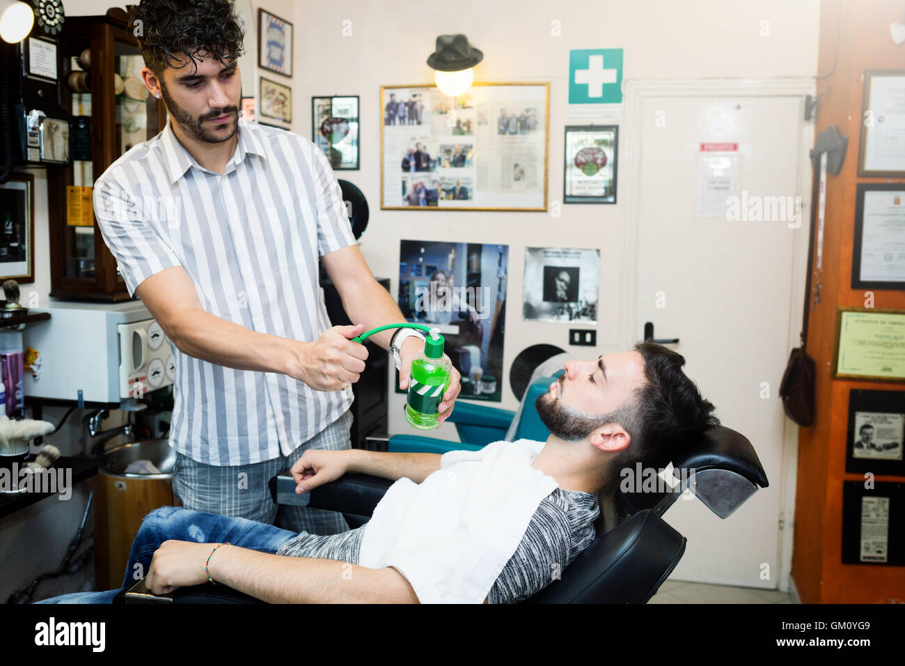 Traditional ritual of shaving the beard in a old style barber shop ...