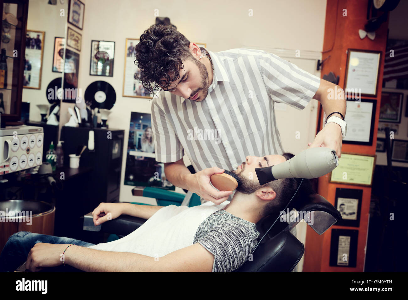 Traditional ritual of shaving the beard in a old style barber shop ...