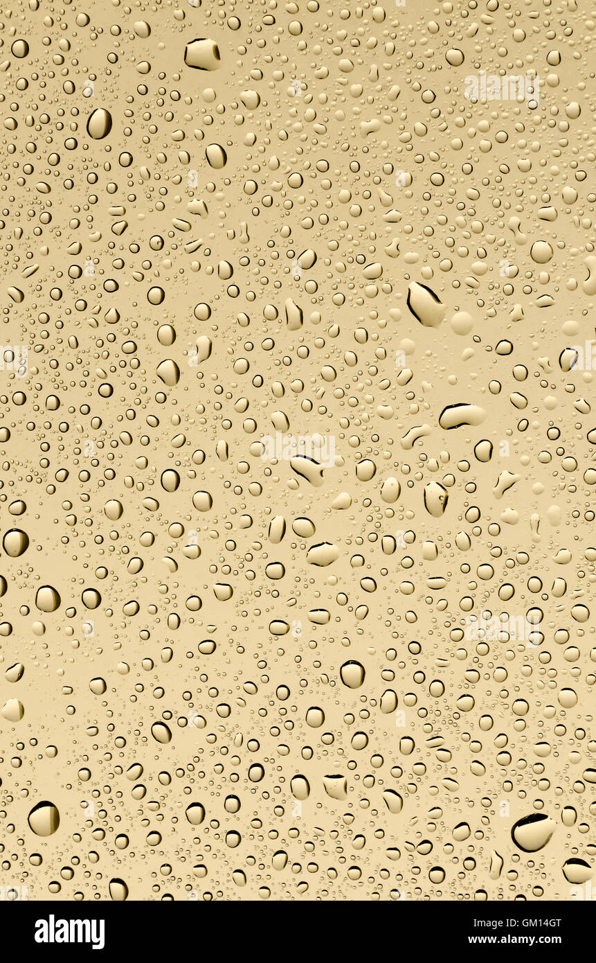 Drops on glass, sand-yellow background Stock Photo - Alamy