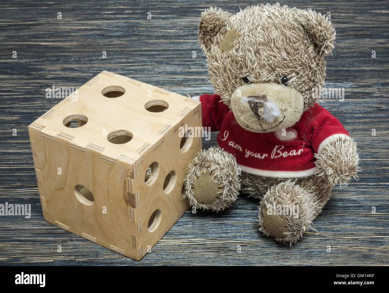 Teddy bear, big dice on old wood table Stock Photo - Alamy