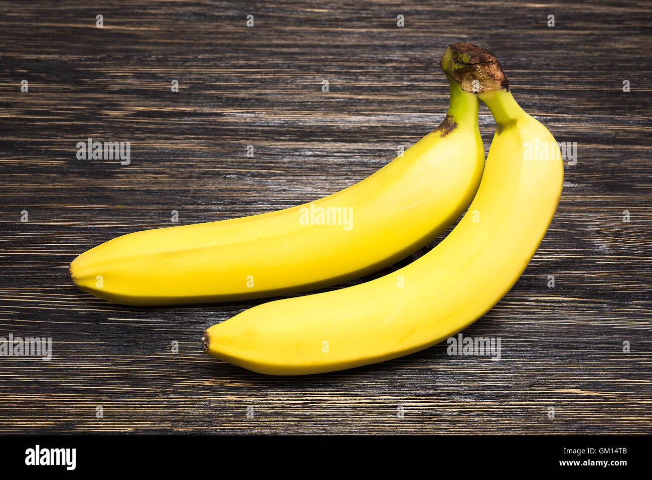 Fresh bananas on wooden background Stock Photo - Alamy