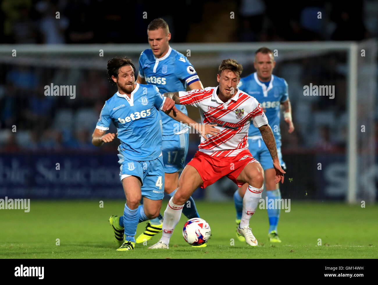 Stoke City's Joe Allen (left) and Stevenage's Jake Hyde (right) battle ...