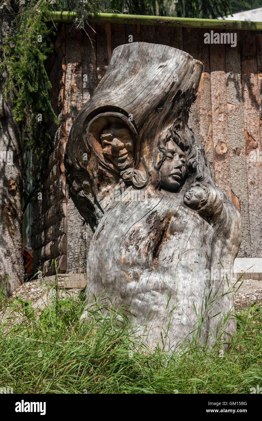 A wooden-craft trunk with some faces used as decoration along a ...