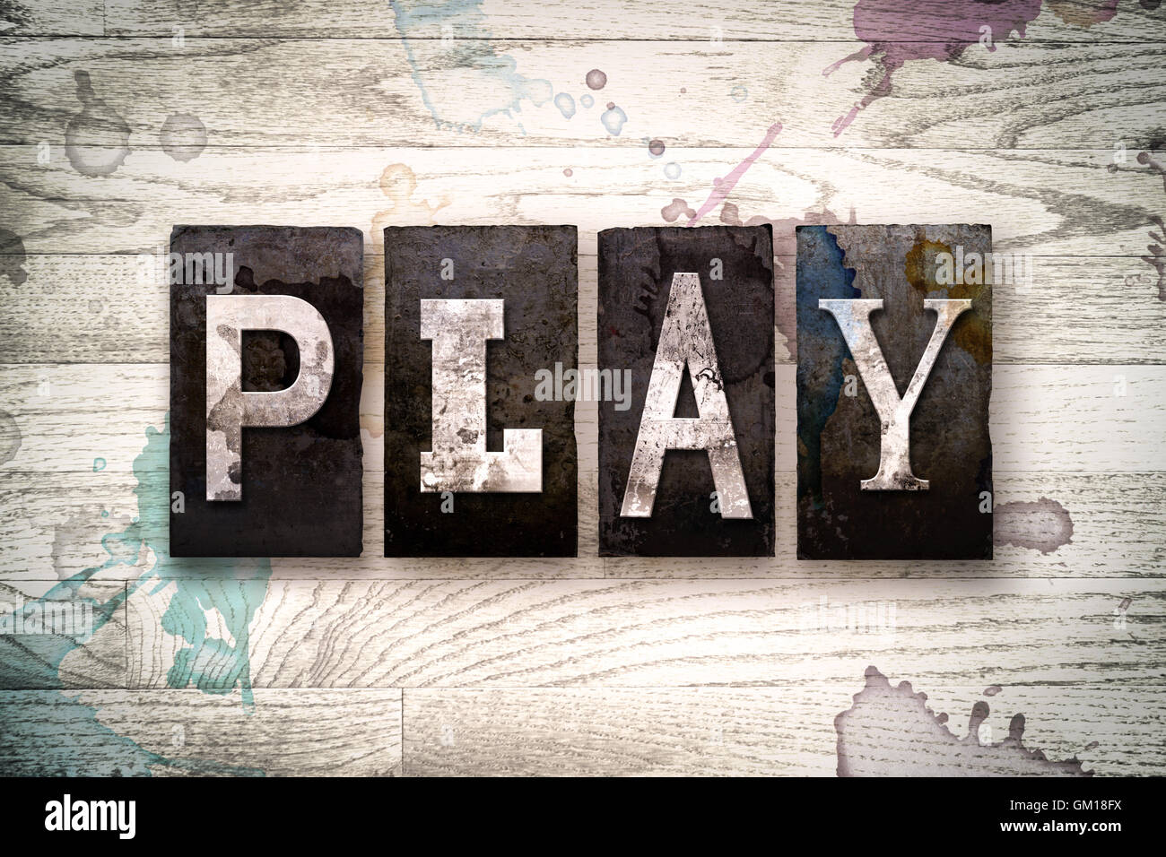 The word "PLAY" written in vintage dirty metal letterpress type on a ...