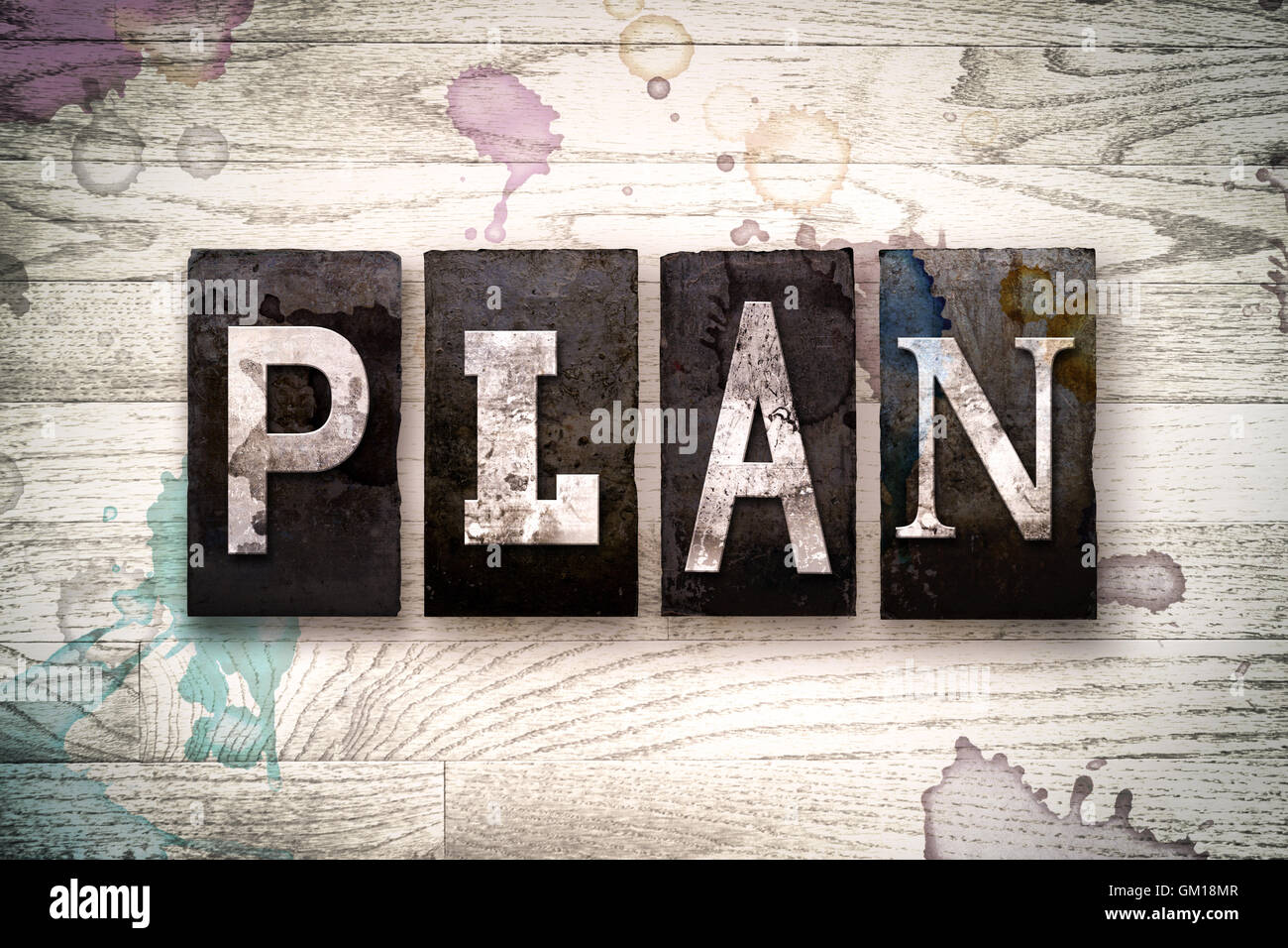 The word "PLAN" written in vintage dirty metal letterpress type on a ...