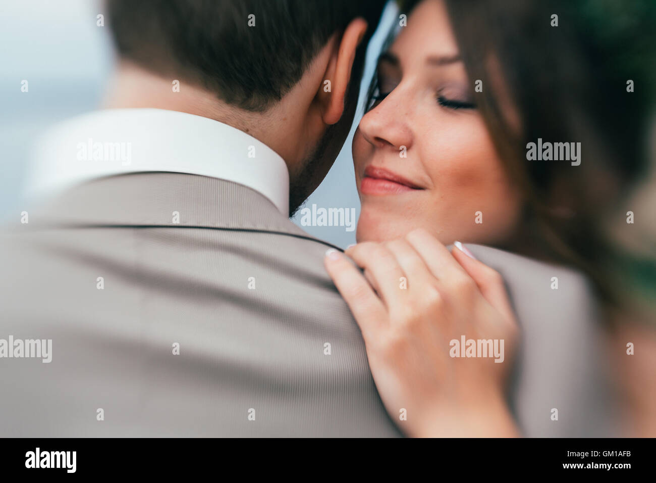 young beautiful happy bride embraces groom soft focus Stock Photo - Alamy