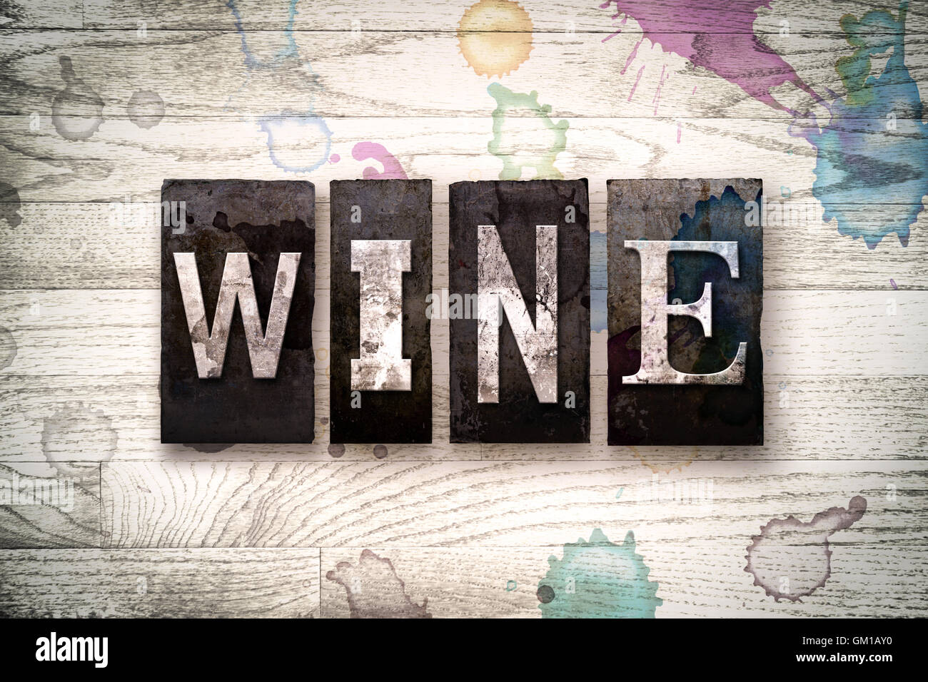 The word "WINE" written in vintage dirty metal letterpress type on a ...