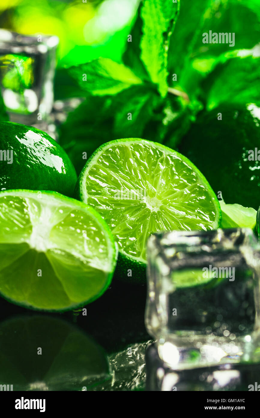 fresh green mint and lime ice cube close-up on a dark background Stock ...