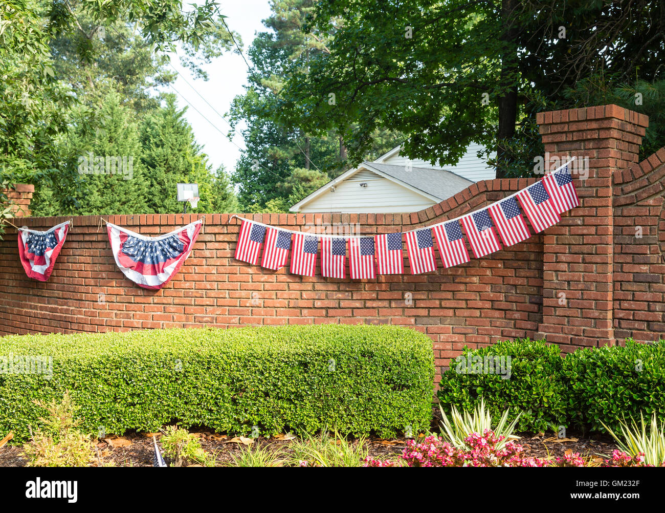 Flags and Bunting on Brick Wall in Neighborhood Stock Photo - Alamy
