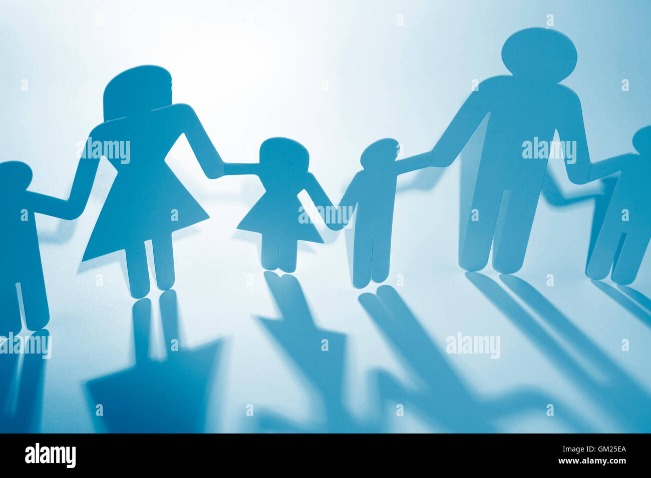 Family paper chain cutout holding hands Stock Photo - Alamy