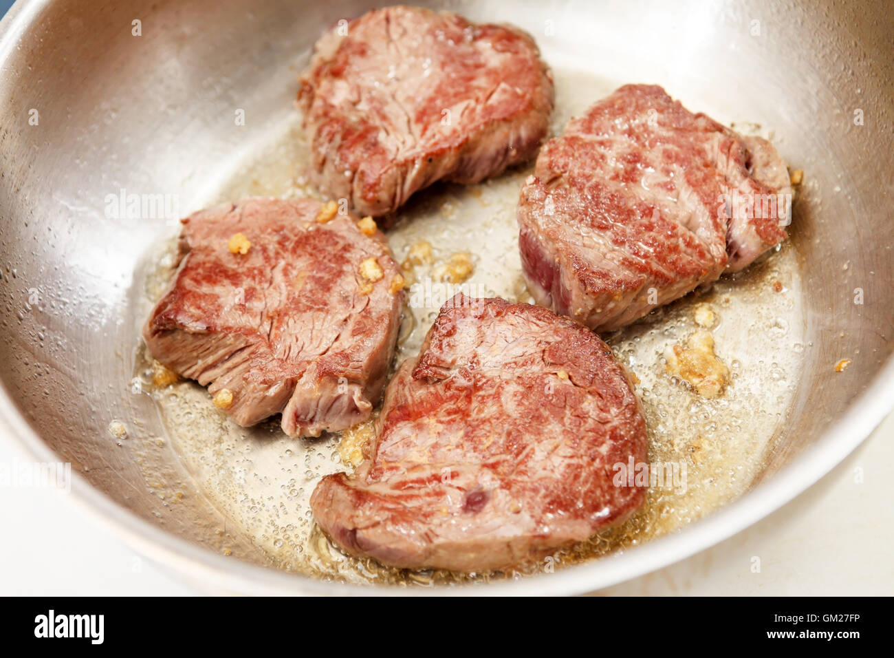 beef steak in a frying pan Stock Photo - Alamy