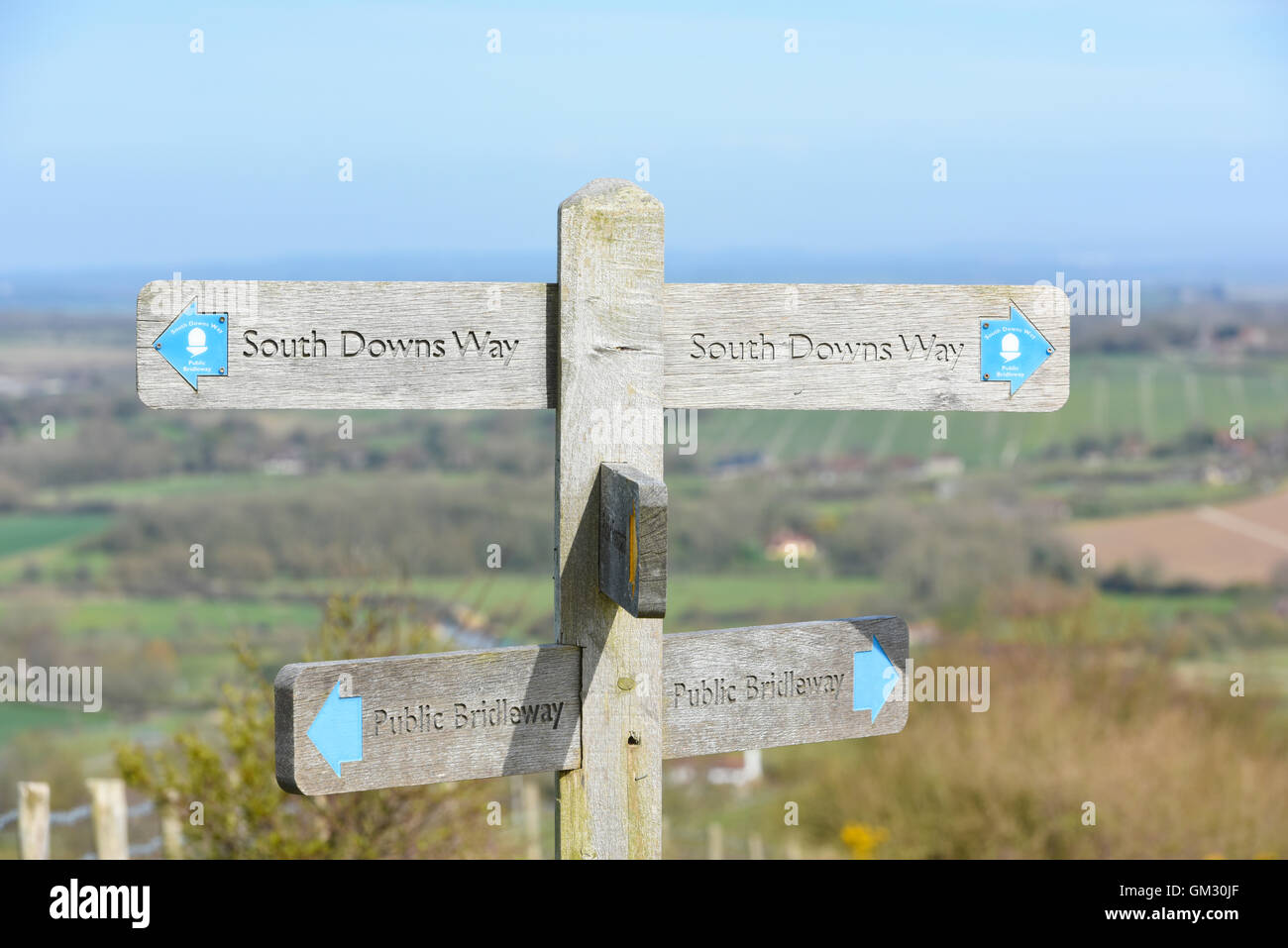 A wooden sign showing the direction of The South Downs Way in Sussex ...