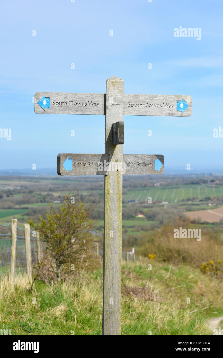 A wooden sign showing the direction of The South Downs Way in Sussex ...