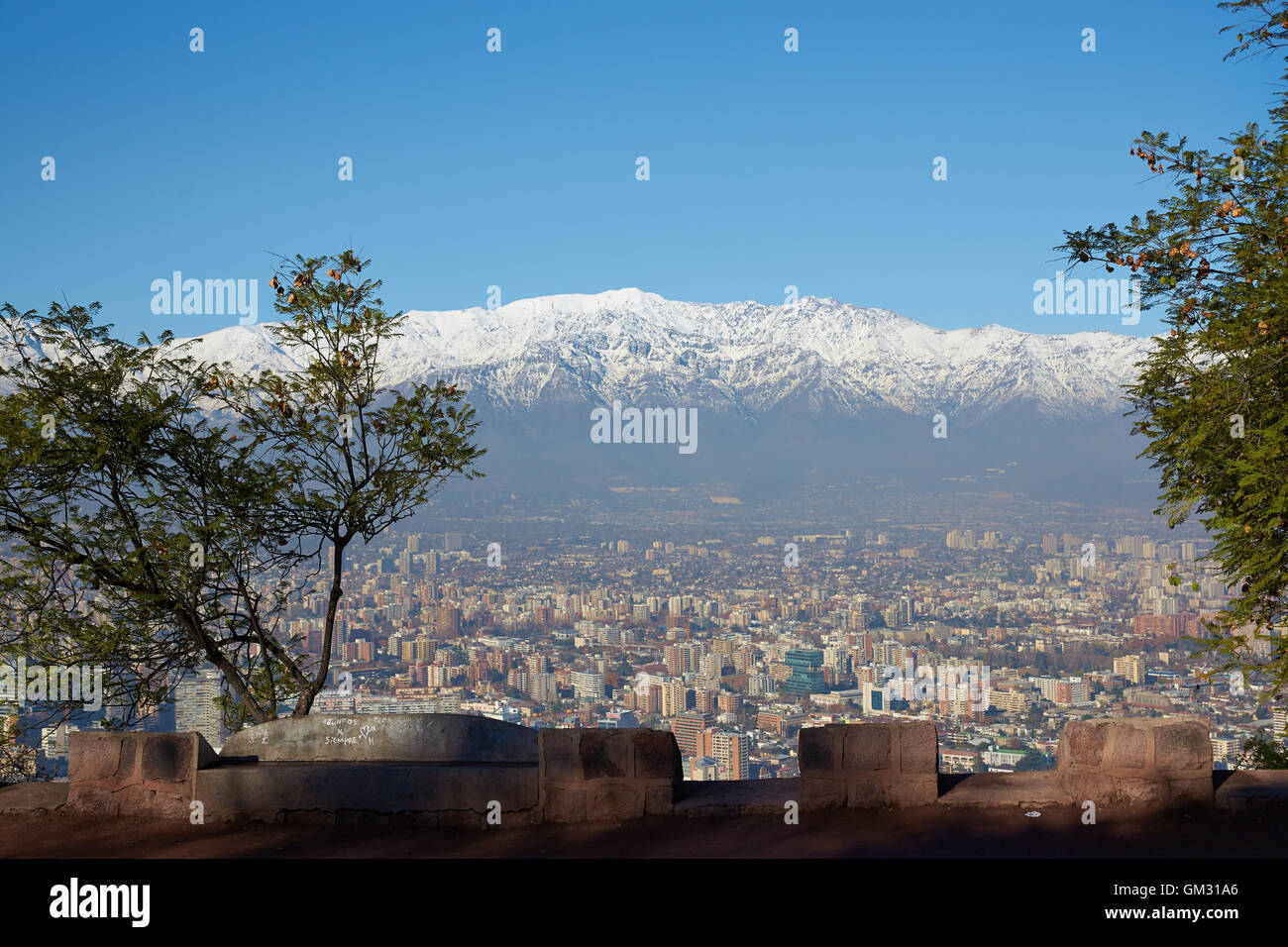 Snow covered mountains surrounding the modern high rise buildings of ...