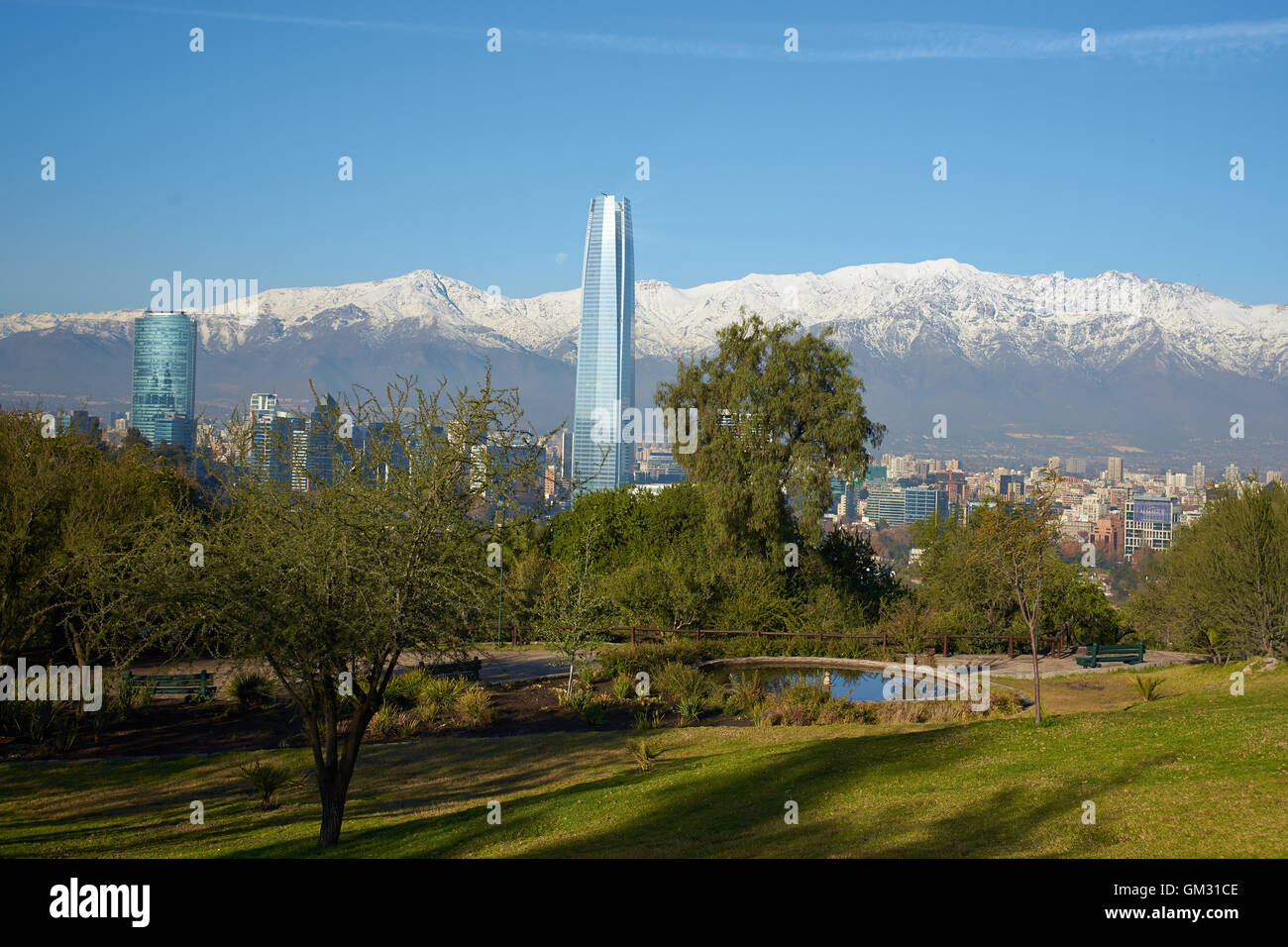 Snow covered mountains surrounding the modern high rise buildings of ...