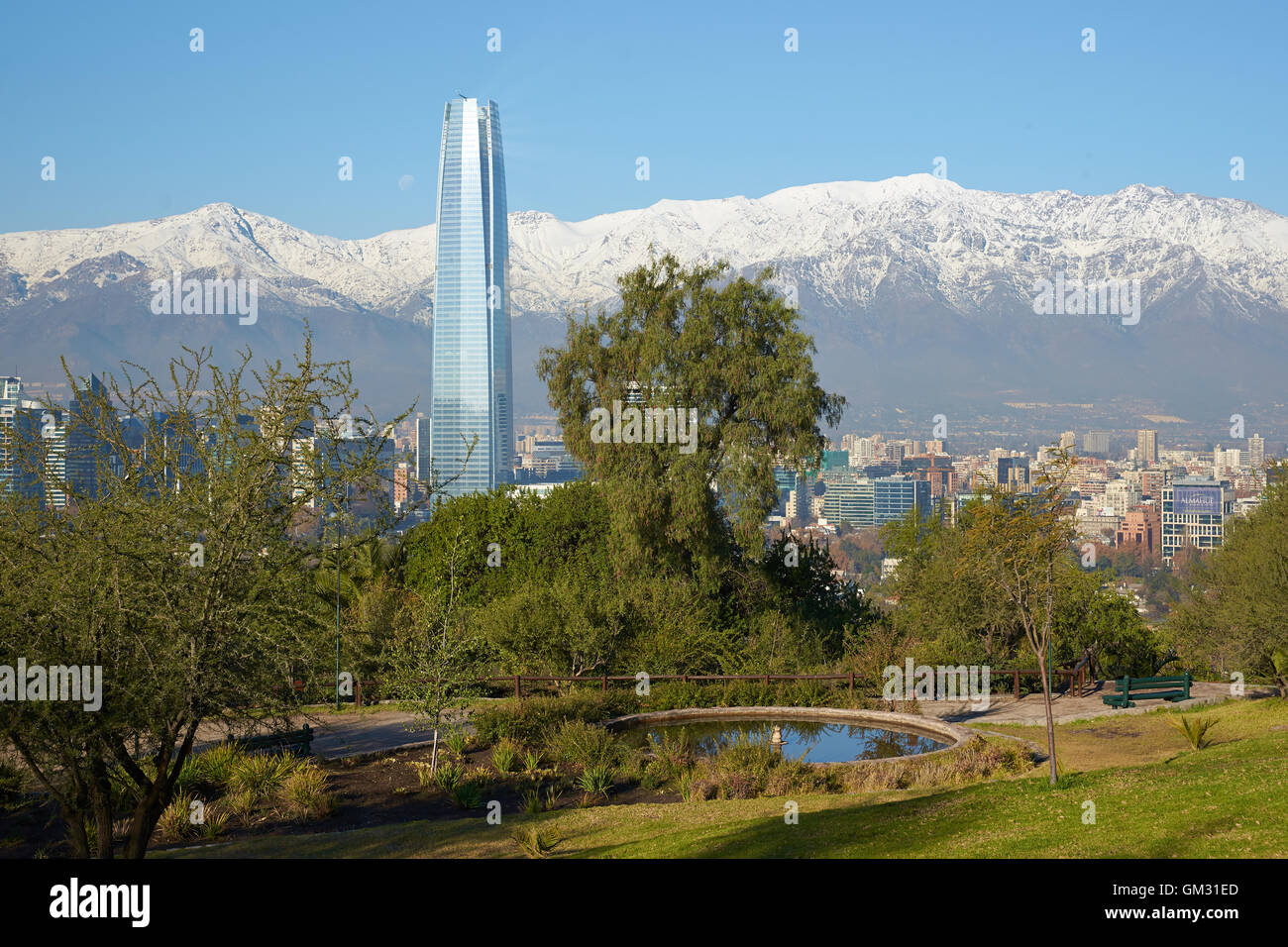 Snow covered mountains surrounding the modern high rise buildings of ...