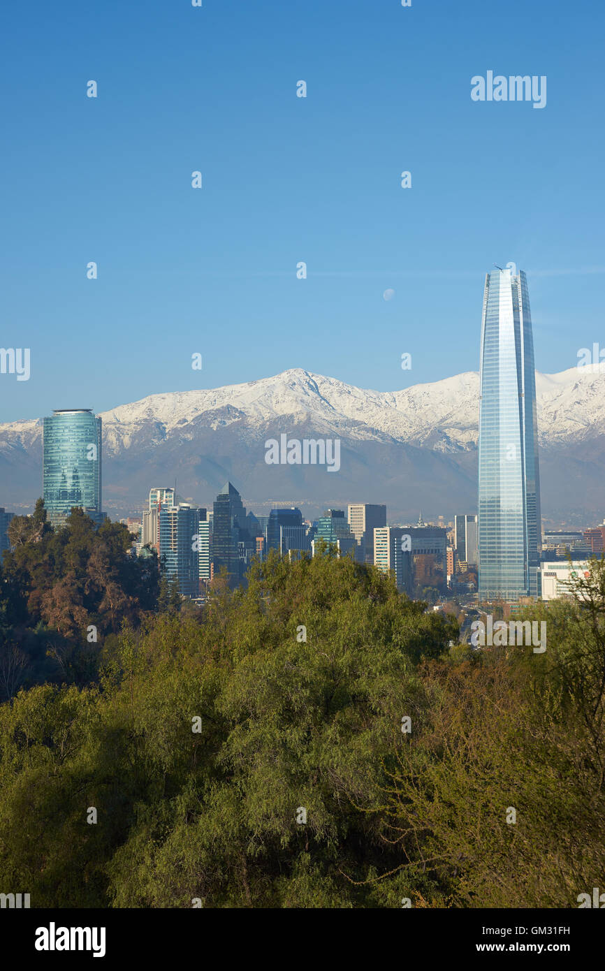 Snow covered mountains surrounding the modern high rise buildings of ...