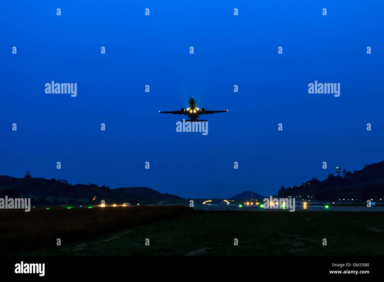 Passenger Airplane take off from runways at night Stock Photo - Alamy
