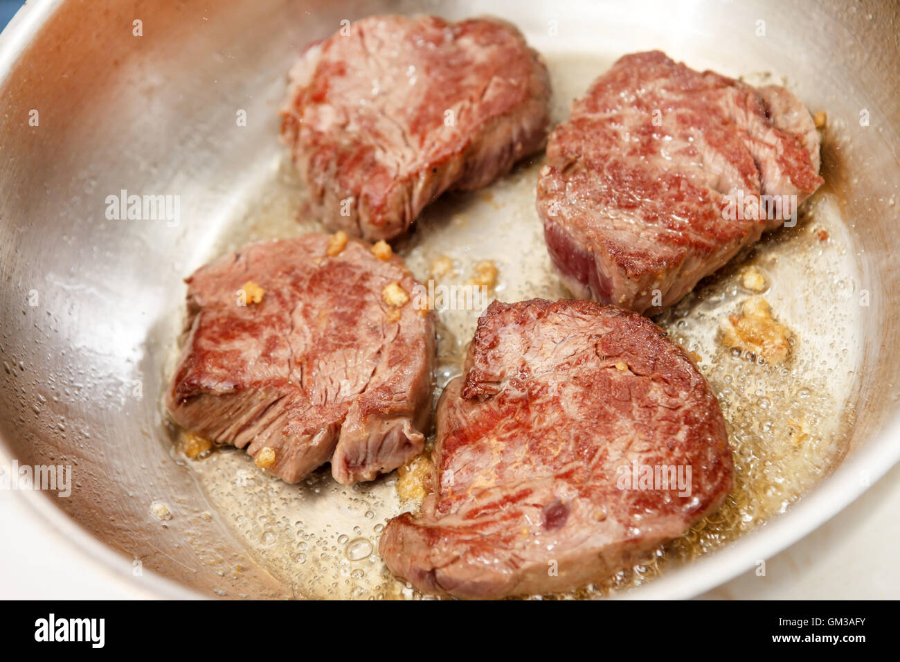 beef steak in a frying pan Stock Photo - Alamy
