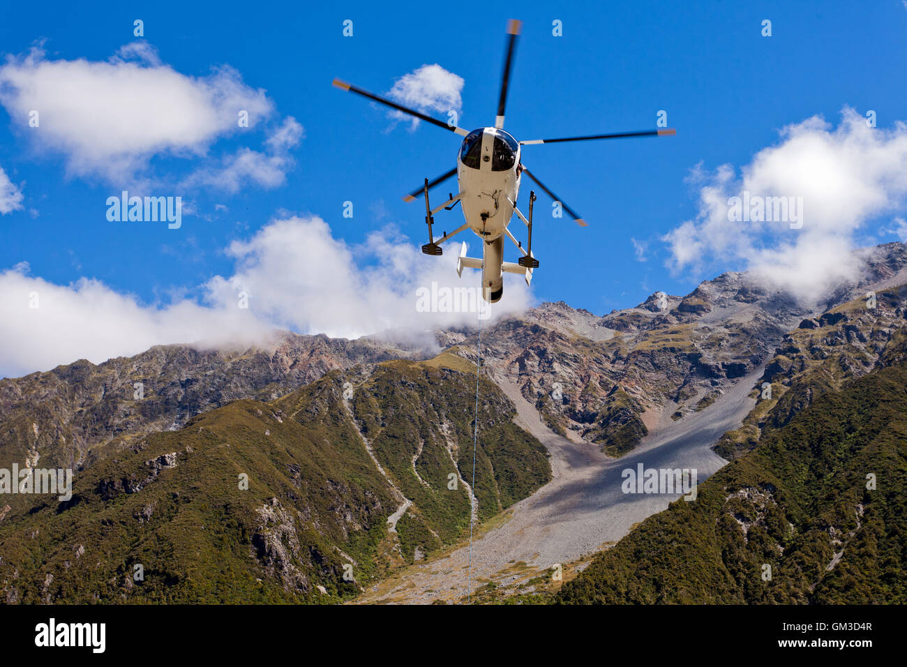 Rescue helicopter fly over mountainous wilderness Stock Photo - Alamy