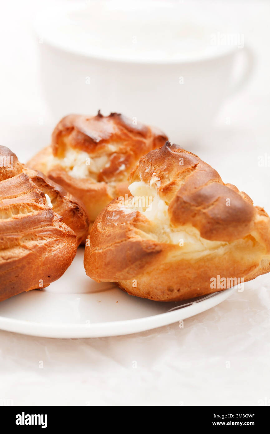eclairs filled with fresh cream Stock Photo - Alamy