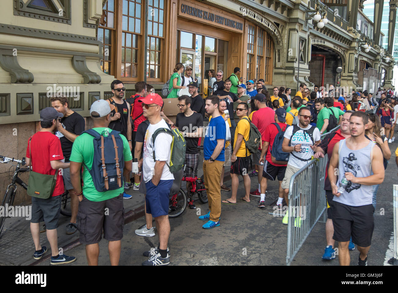 People congregate as they are waiting to board the Governor's Island ...
