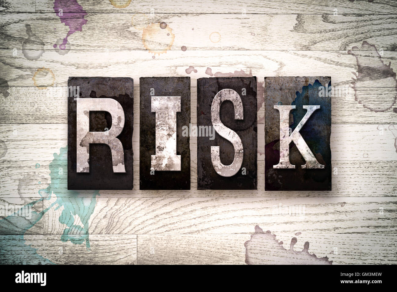 The word "RISK" written in vintage dirty metal letterpress type on a ...