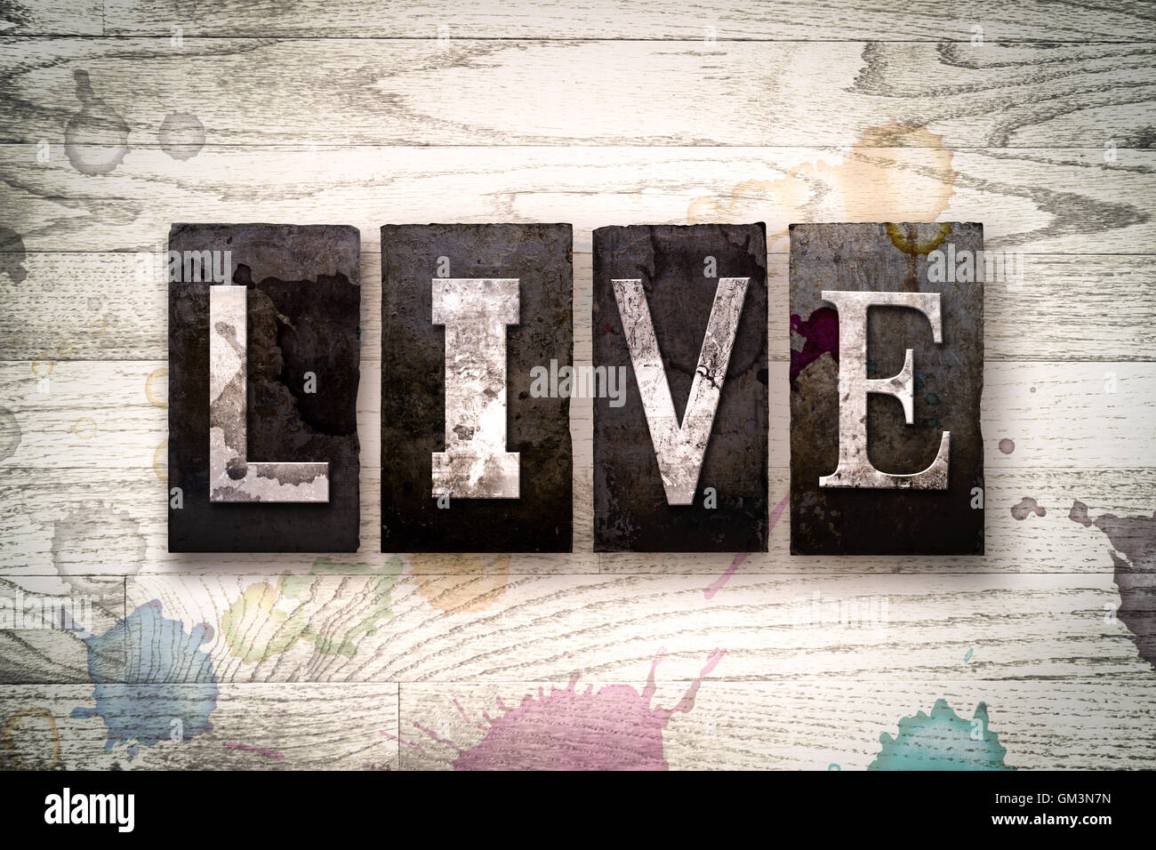 The word "LIVE" written in vintage dirty metal letterpress type on a ...