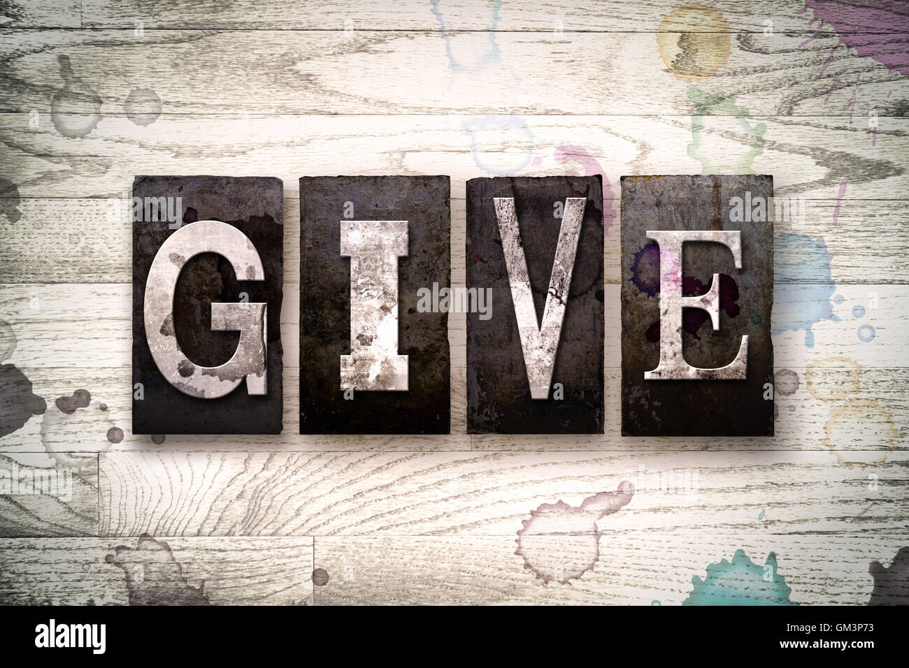 The word "GIVE" written in vintage dirty metal letterpress type on a ...