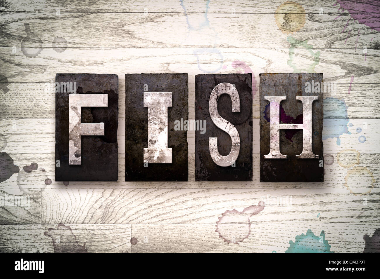 The word "FISH" written in vintage dirty metal letterpress type on a ...