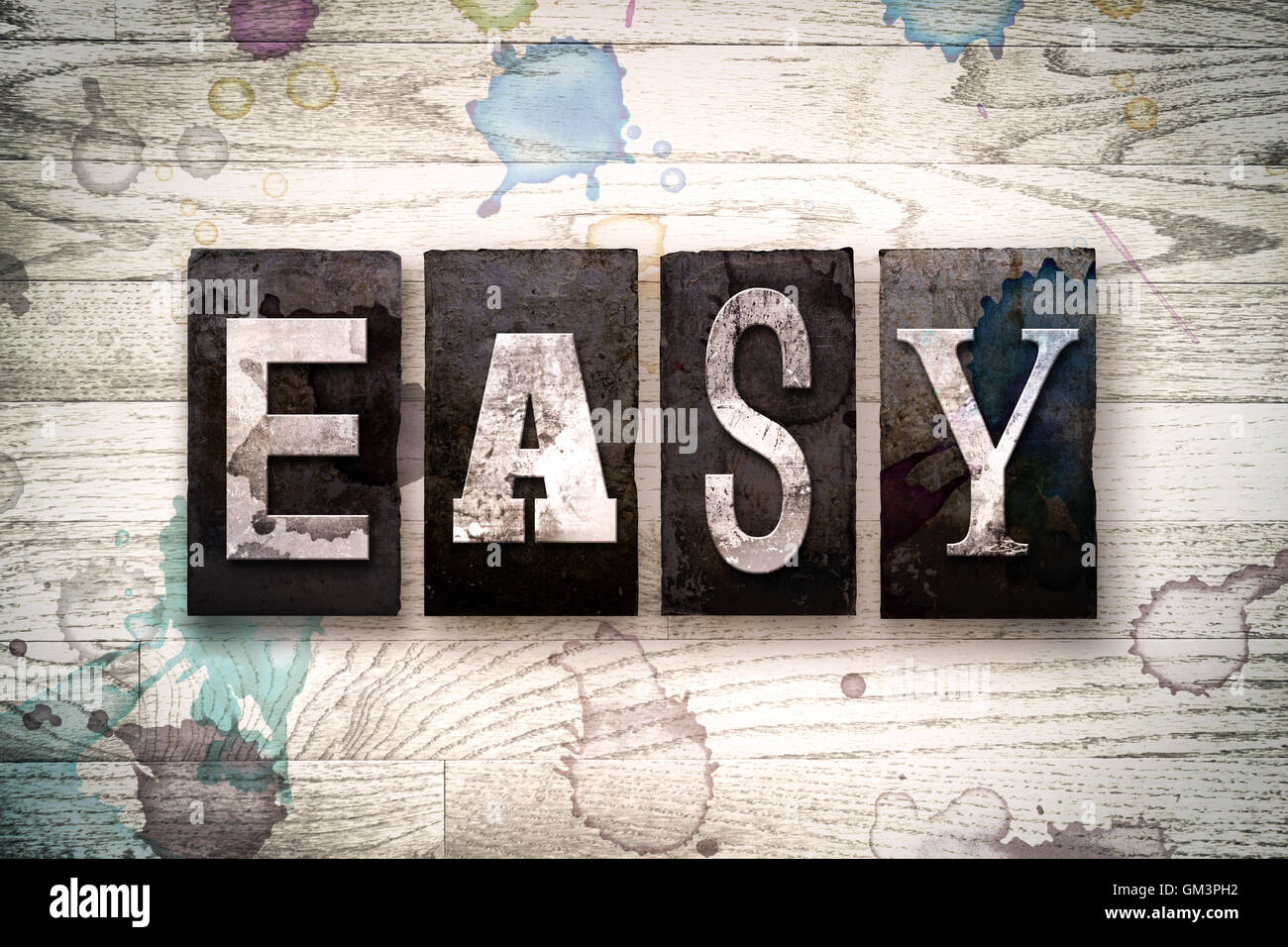 The word "EASY" written in vintage dirty metal letterpress type on a ...