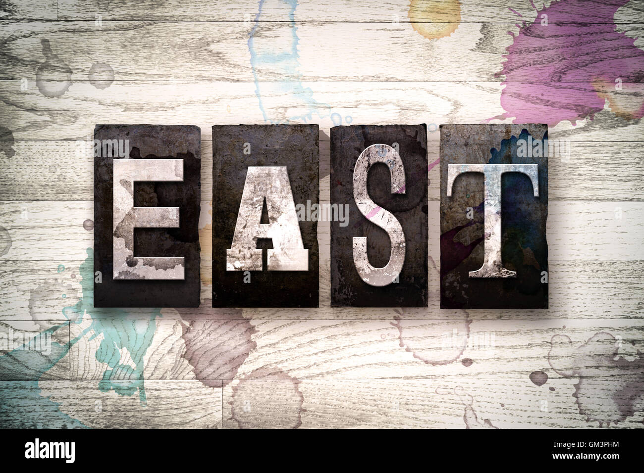 The word "EAST" written in vintage dirty metal letterpress type on a ...