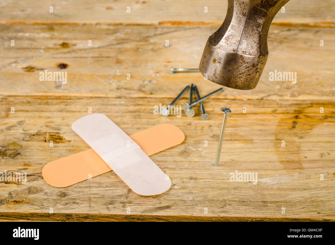 Hammer nails and band aid, a domestic DIY accident concept Stock Photo ...