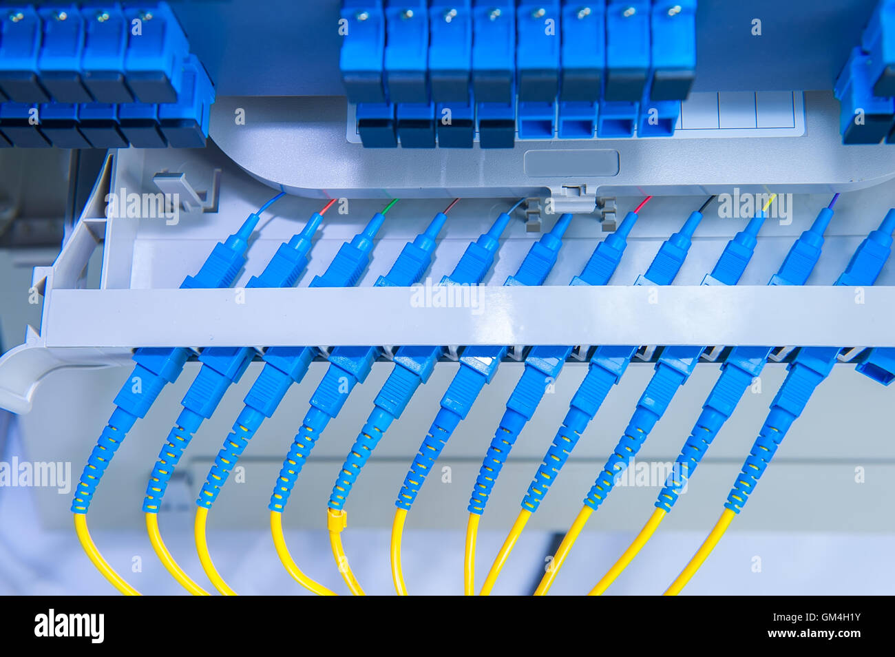 Fiber network switch with some yellow optical network cables Stock ...