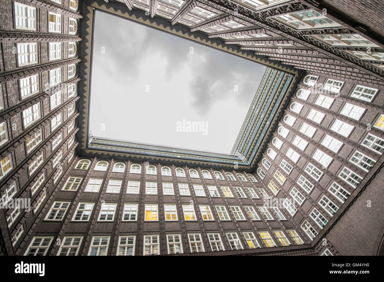 view in a courtyard with many windows into the sky Stock Photo - Alamy