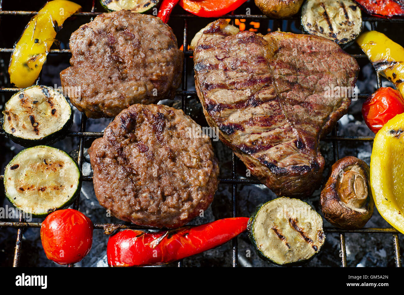Grilled meat with vegetables. Top view Stock Photo - Alamy