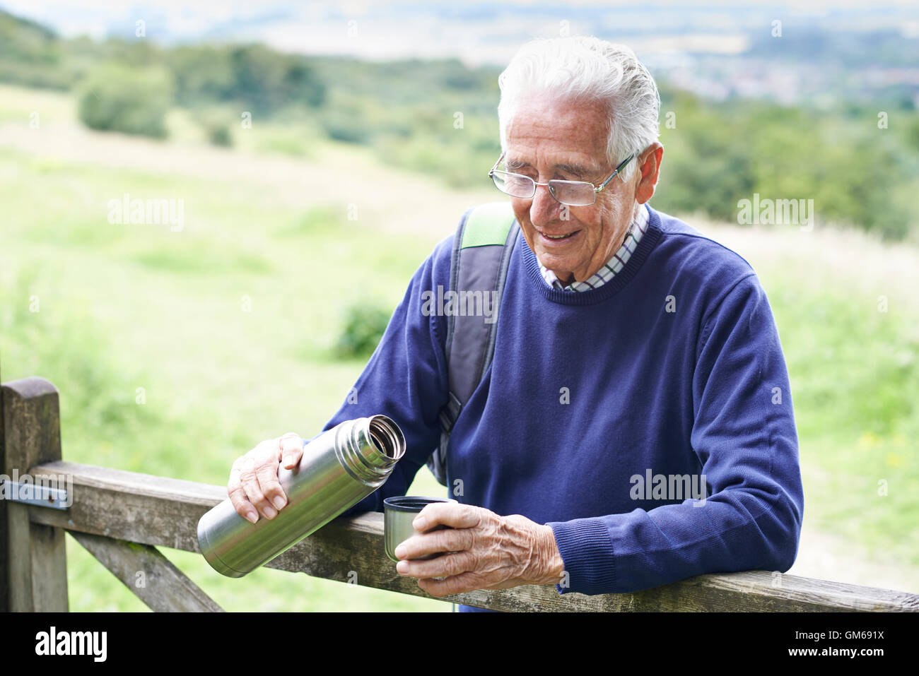 Senior Man Having Drink From Flask Whilst On Walk Stock Photo - Alamy