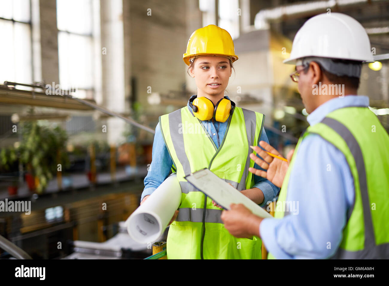 Working in a factory Stock Photo - Alamy