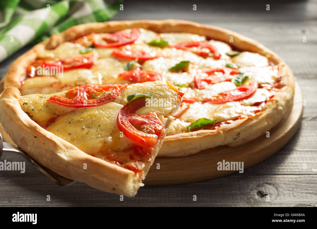italian pizza at wooden table Stock Photo - Alamy