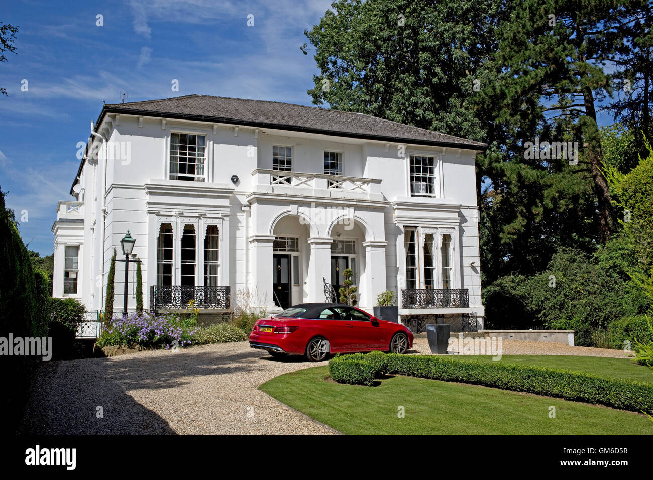 Red Mercedes car parked outside large Georgian Regency town house ...